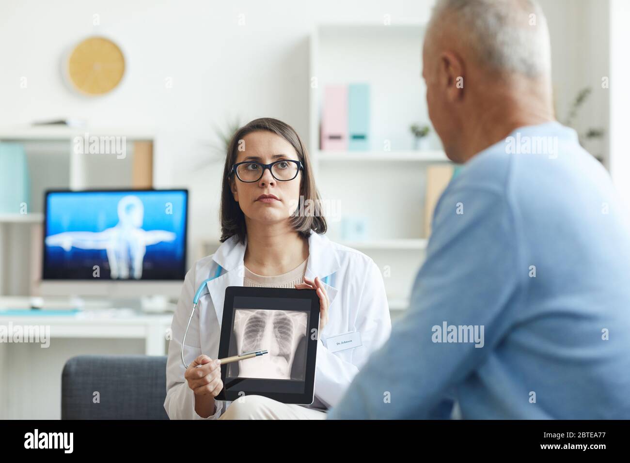 Woman holding her chest doctor hi-res stock photography and images - Alamy