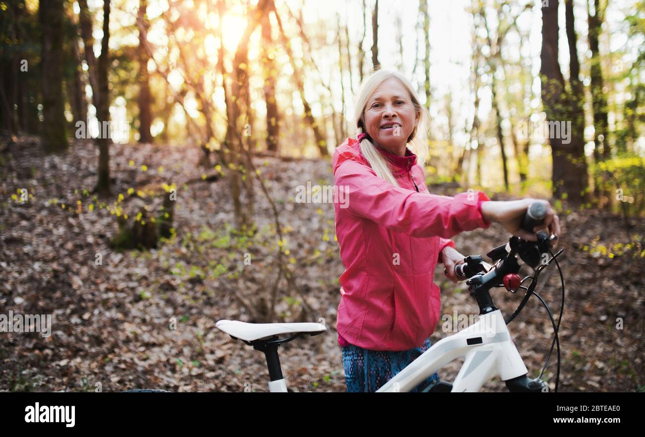 Attractive senior woman standing in nature hi-res stock photography and ...