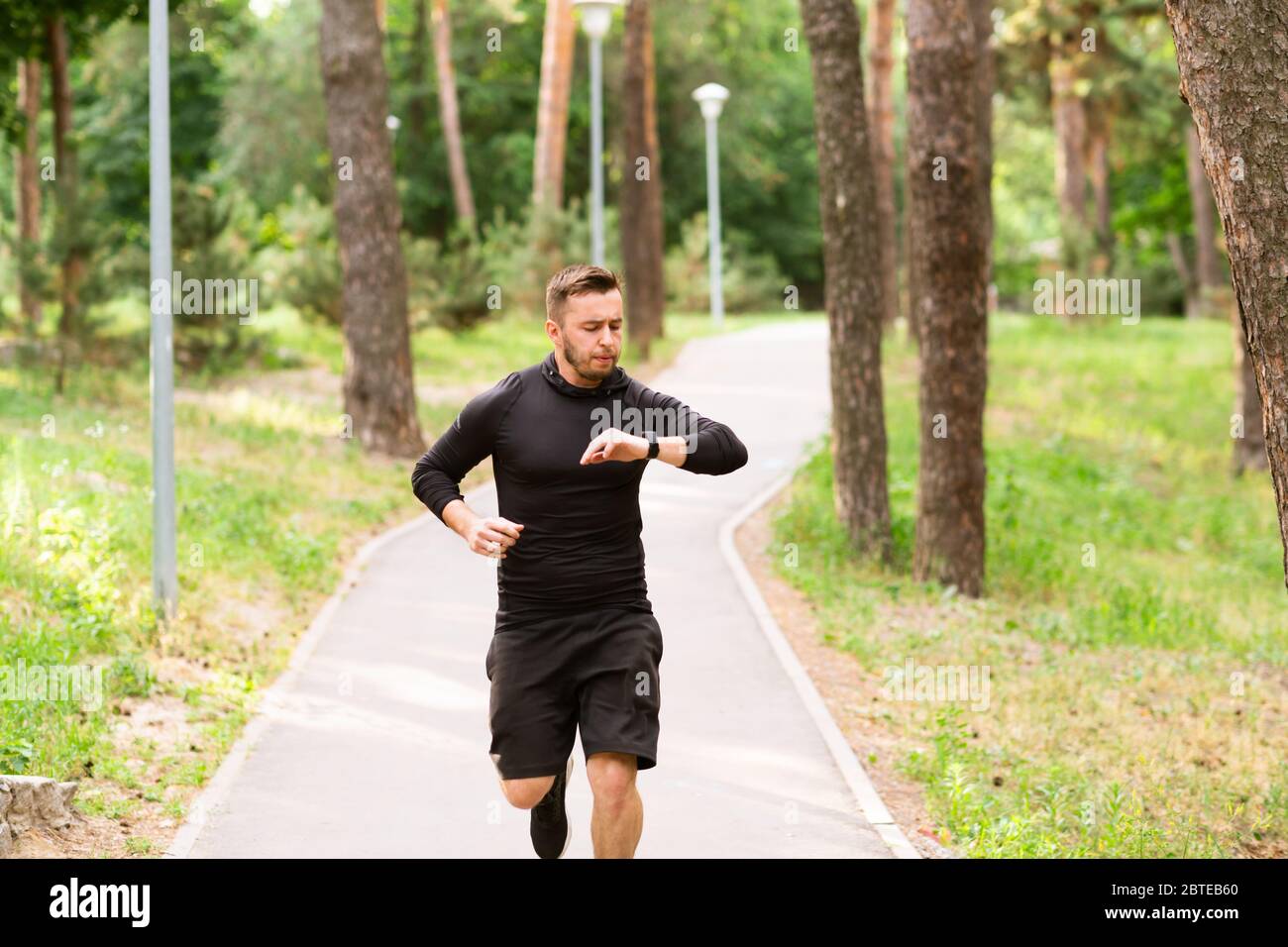 Man running watch park hi-res stock photography and images - Alamy