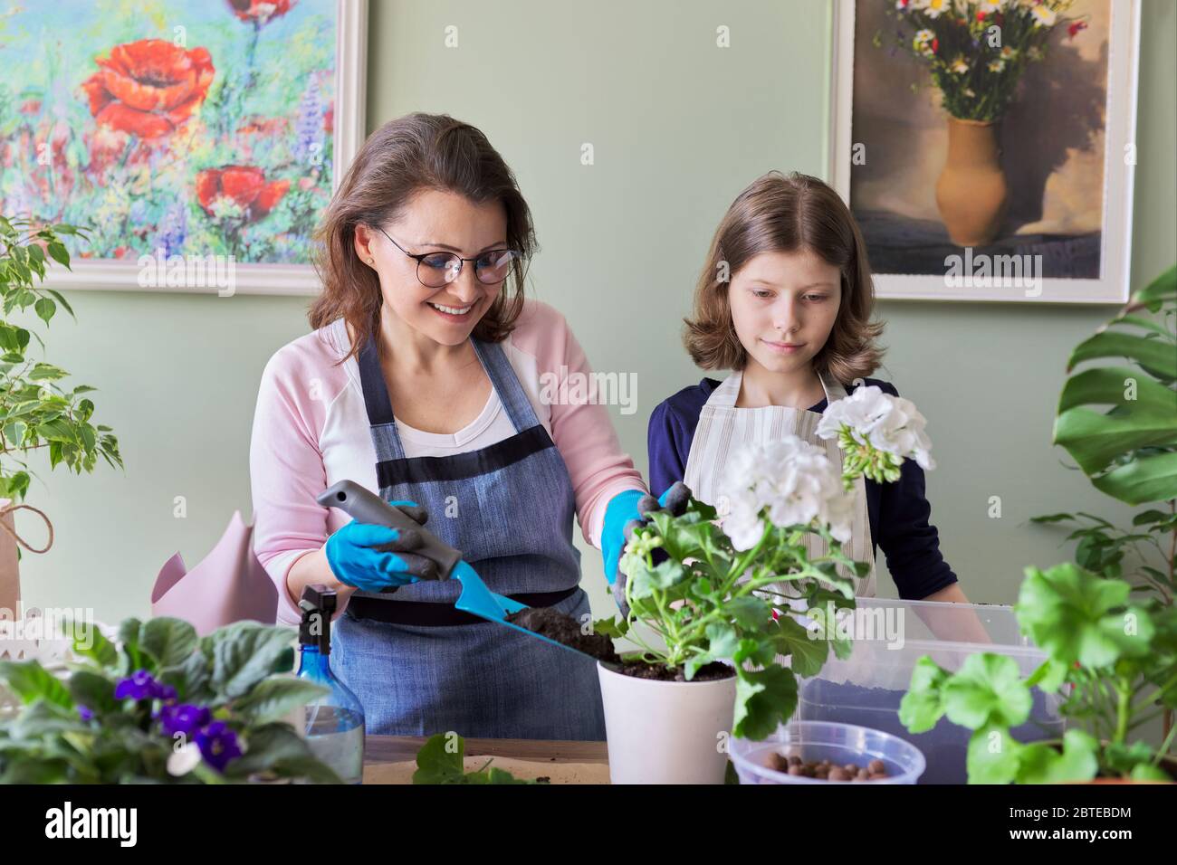 Mother and daughter child plant potted flowers Stock Photo - Alamy