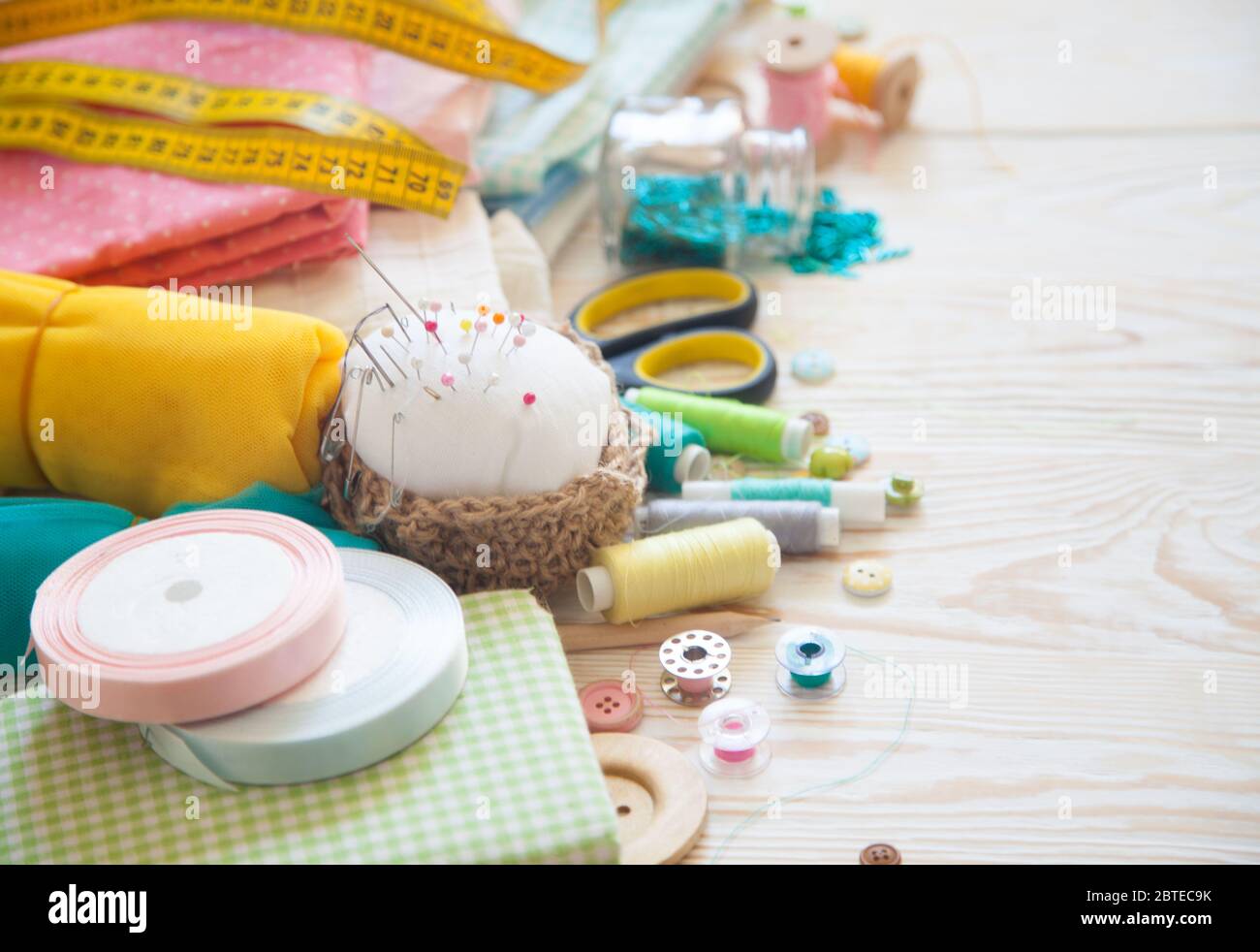 Many different rainbow materials for needlework and sewing. A girl ...