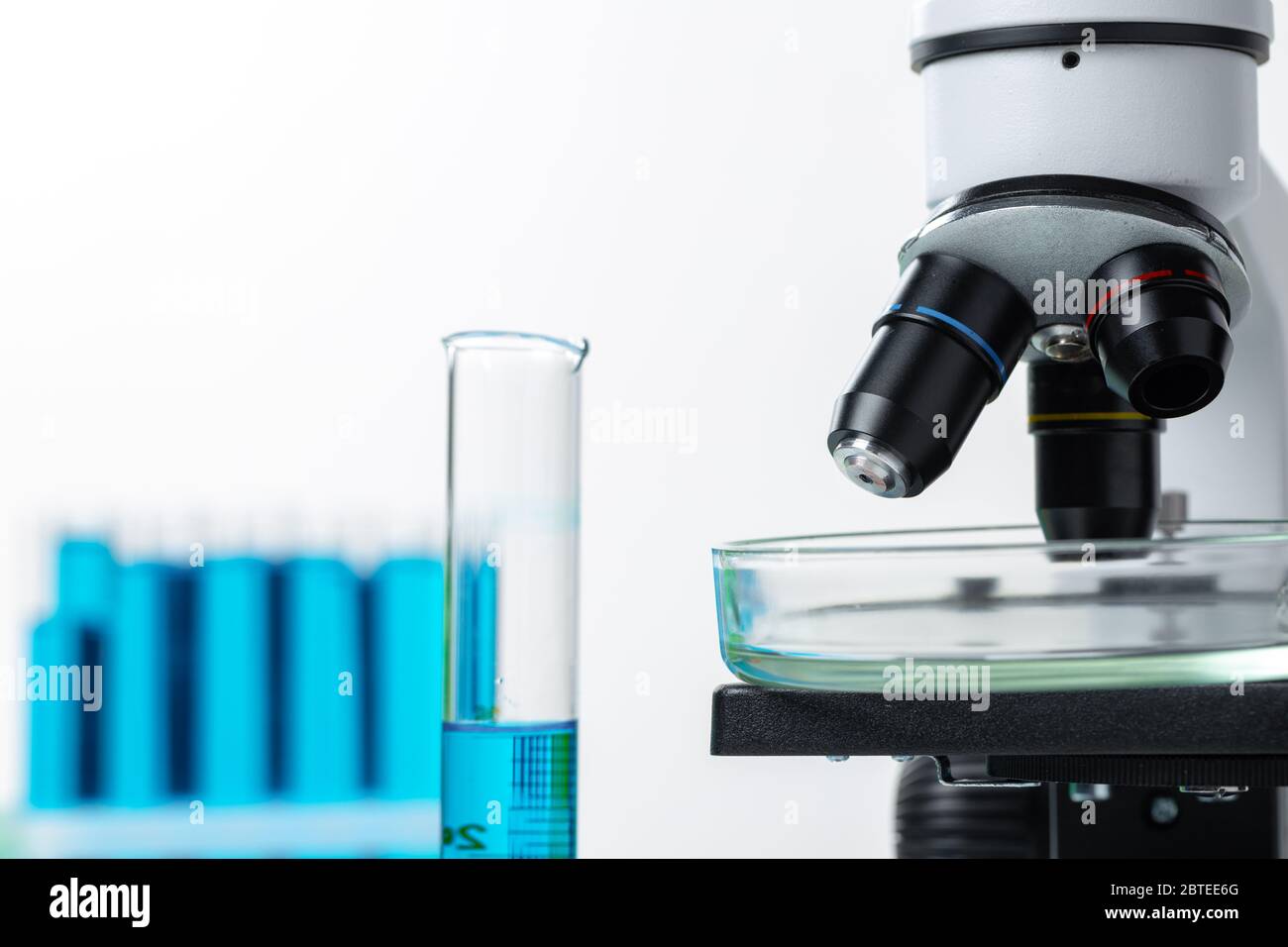 Laboratory microscope with colorful test tubes close up Stock Photo - Alamy