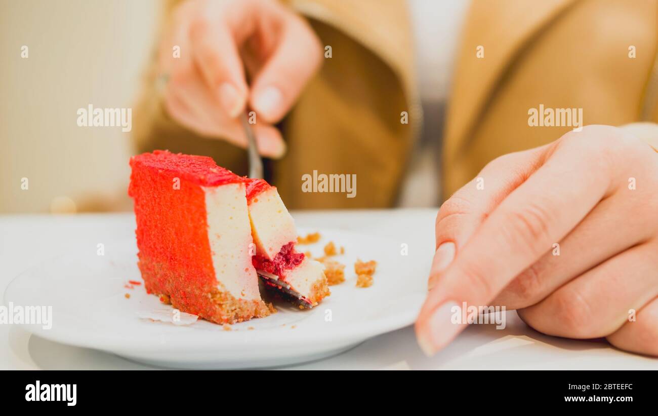 Toned photo of young woman eating sweet cake in cafe Stock Photo - Alamy