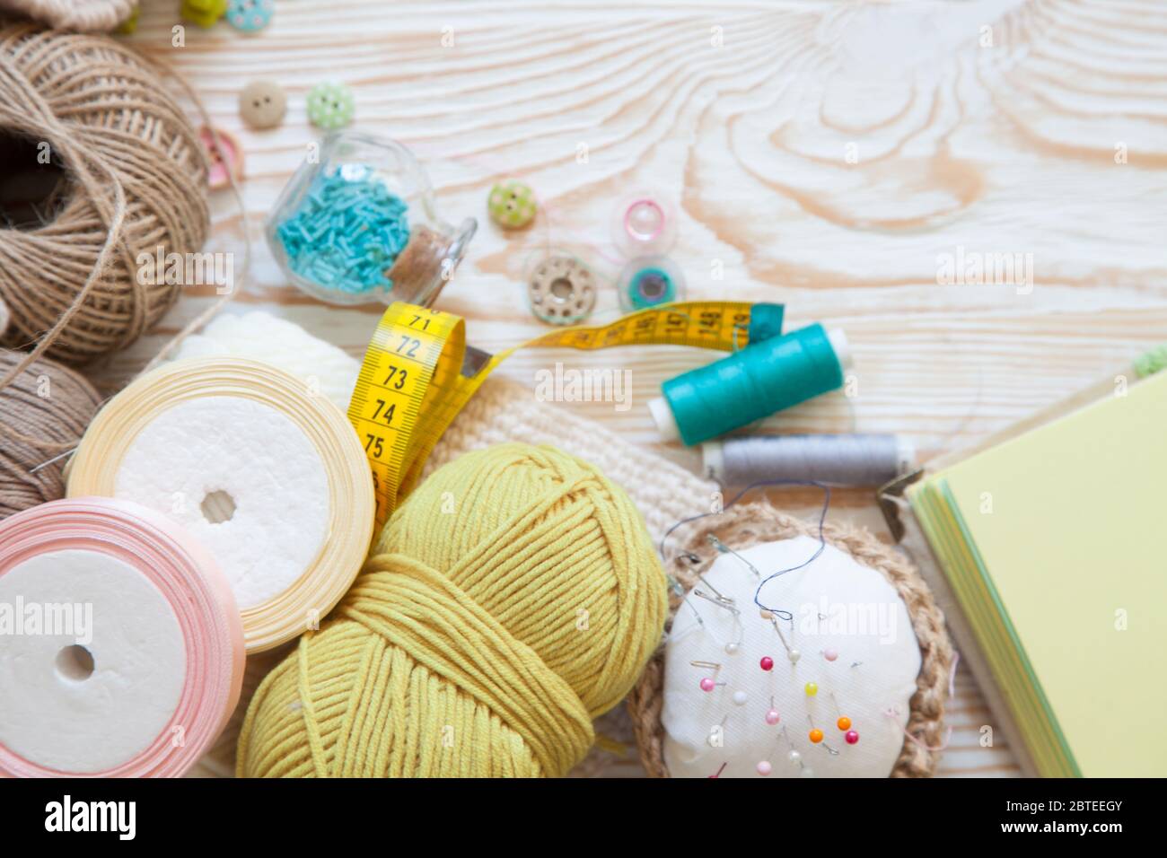 Many different rainbow materials for needlework and sewing. A girl ...
