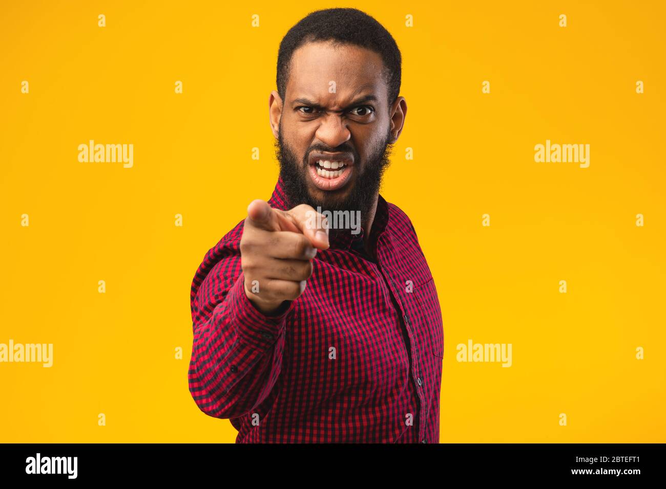 Angry afro man pointing finger at camera Stock Photo - Alamy