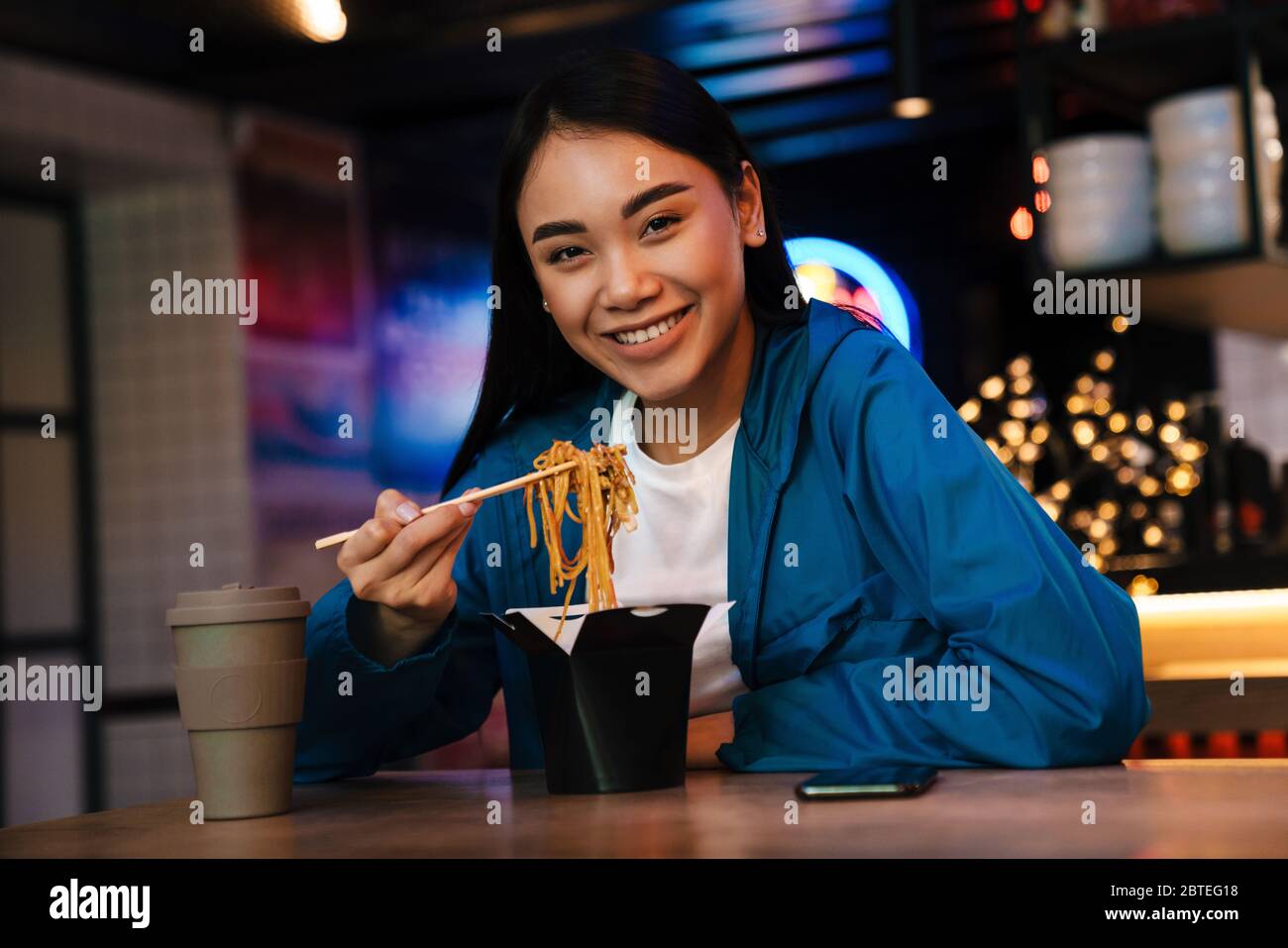 Asian girl eating noodles restaurant hi-res stock photography and ...