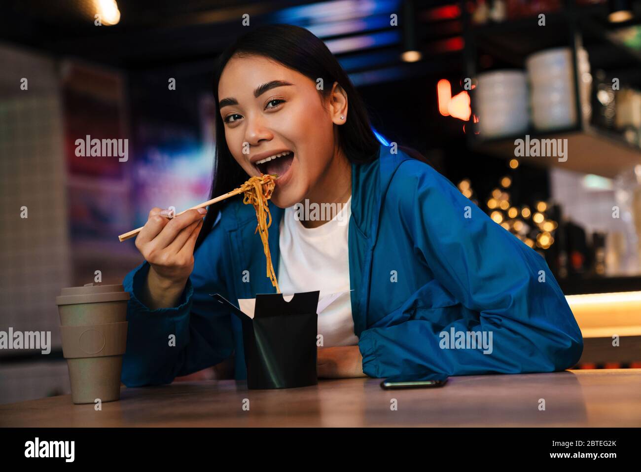 Asian girl eating noodles restaurant hi-res stock photography and ...