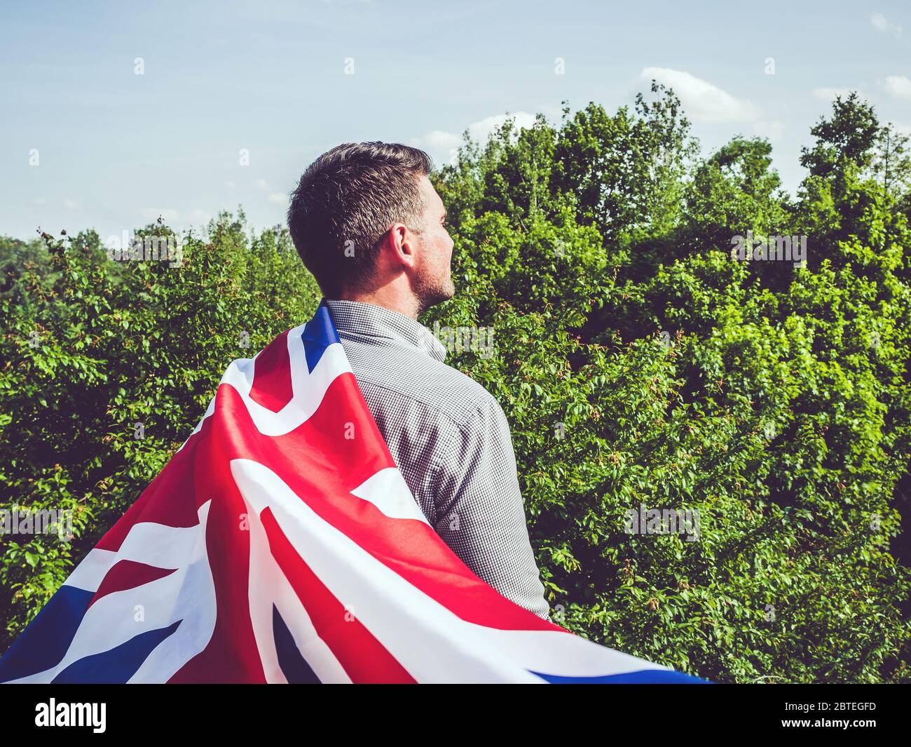 Uk flag waving blue sky hands hi-res stock photography and images - Alamy
