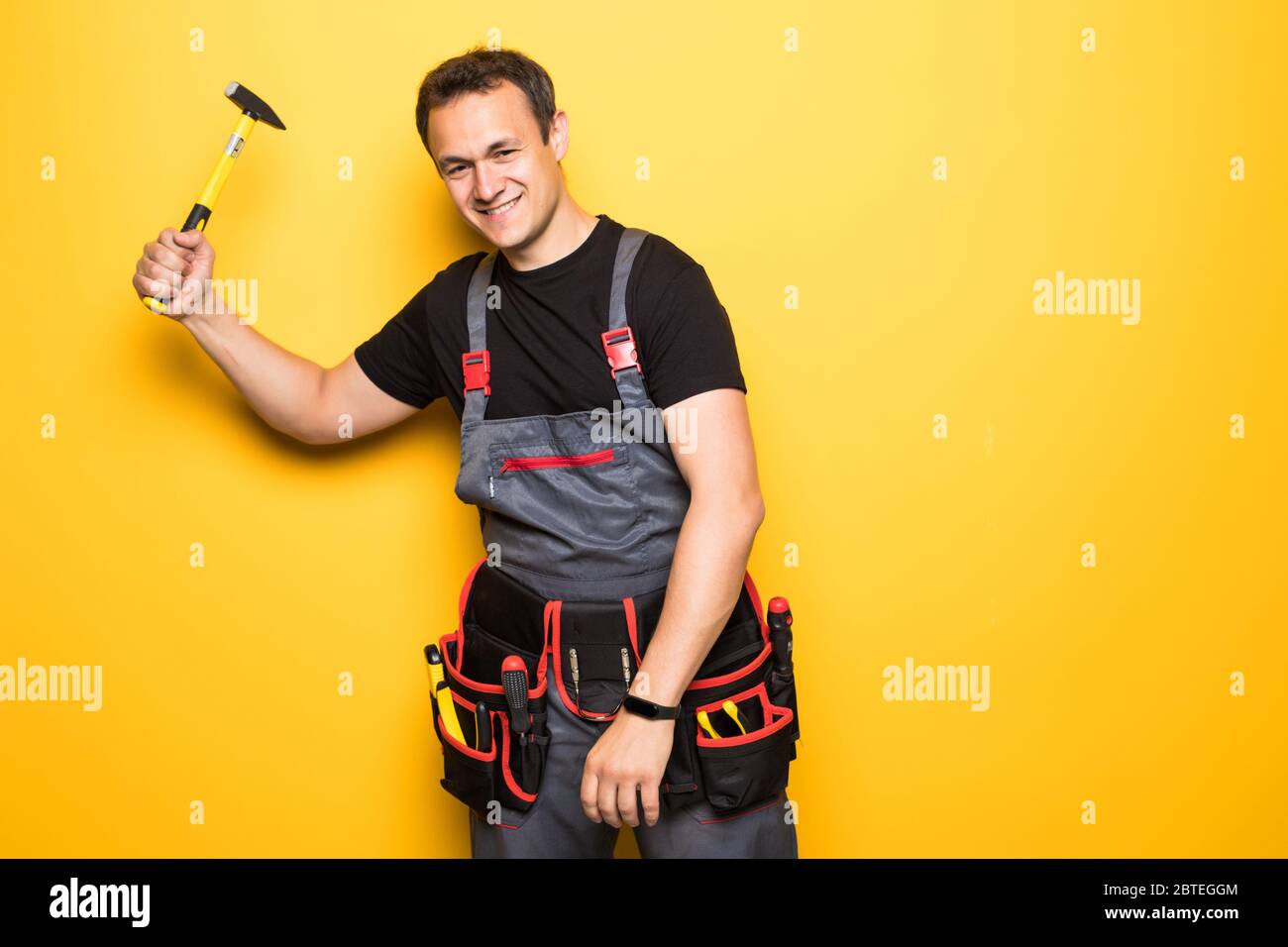 Portrait of repairman raising a hummer and start to work isolated on a ...