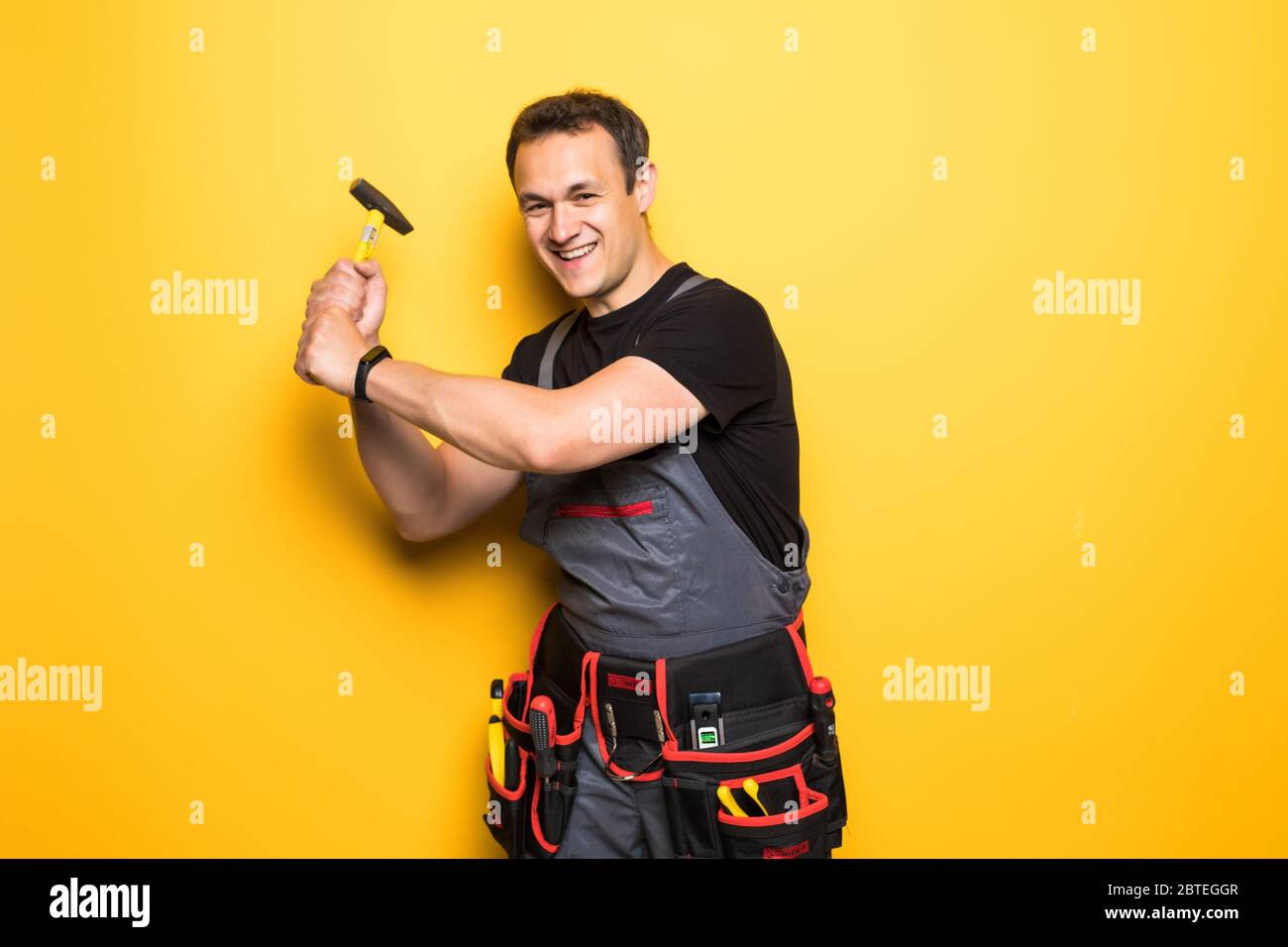 Portrait of repairman raising a hummer and start to work isolated on a ...