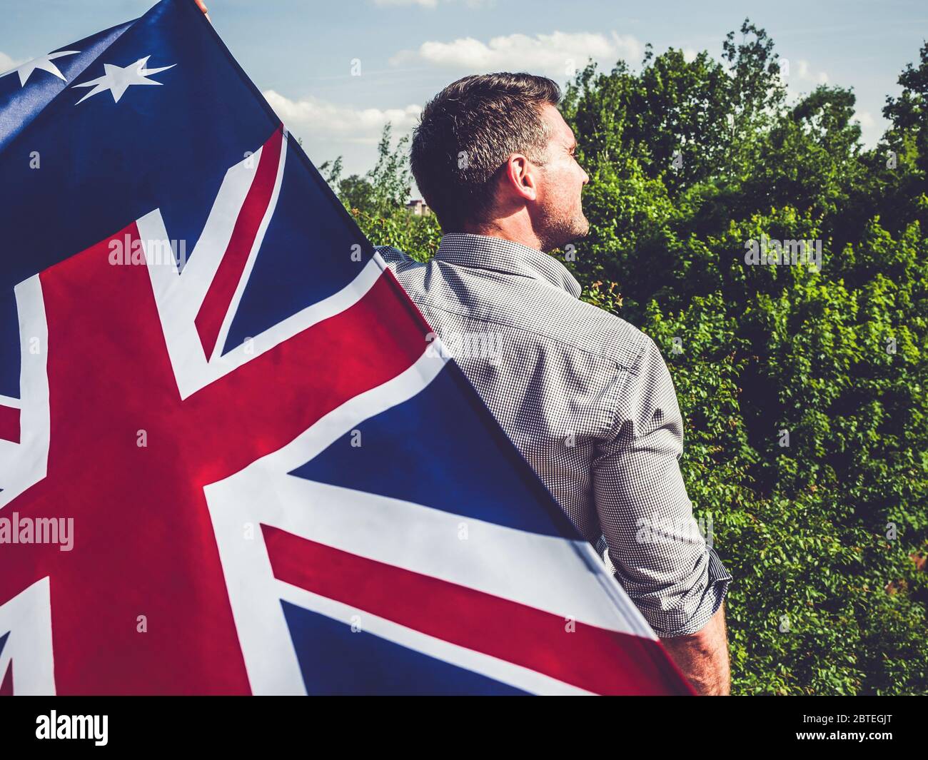 Attractive man holding Australian Flag. National holiday Stock Photo ...