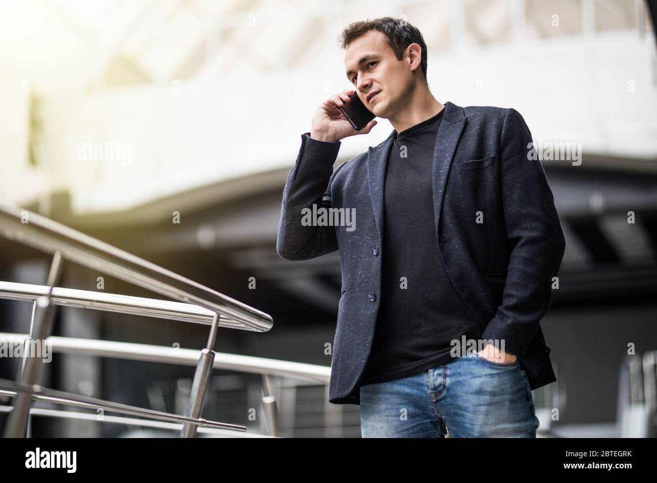 Low angle shot of a corporate executive walking along a modern corridor ...