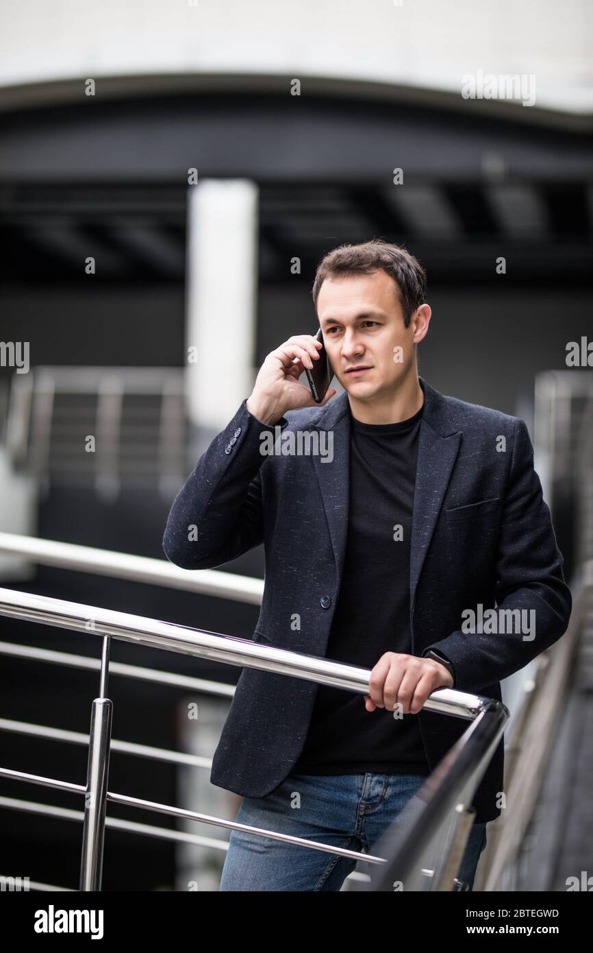 Low angle shot of a corporate executive walking along a modern corridor ...