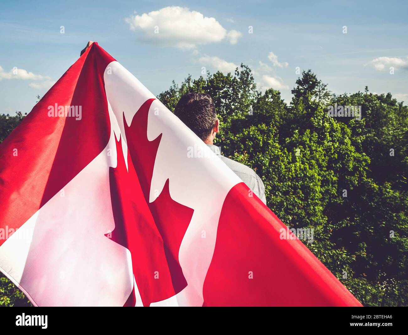 Attractive man holding Canadian Flag. National holiday Stock Photo - Alamy