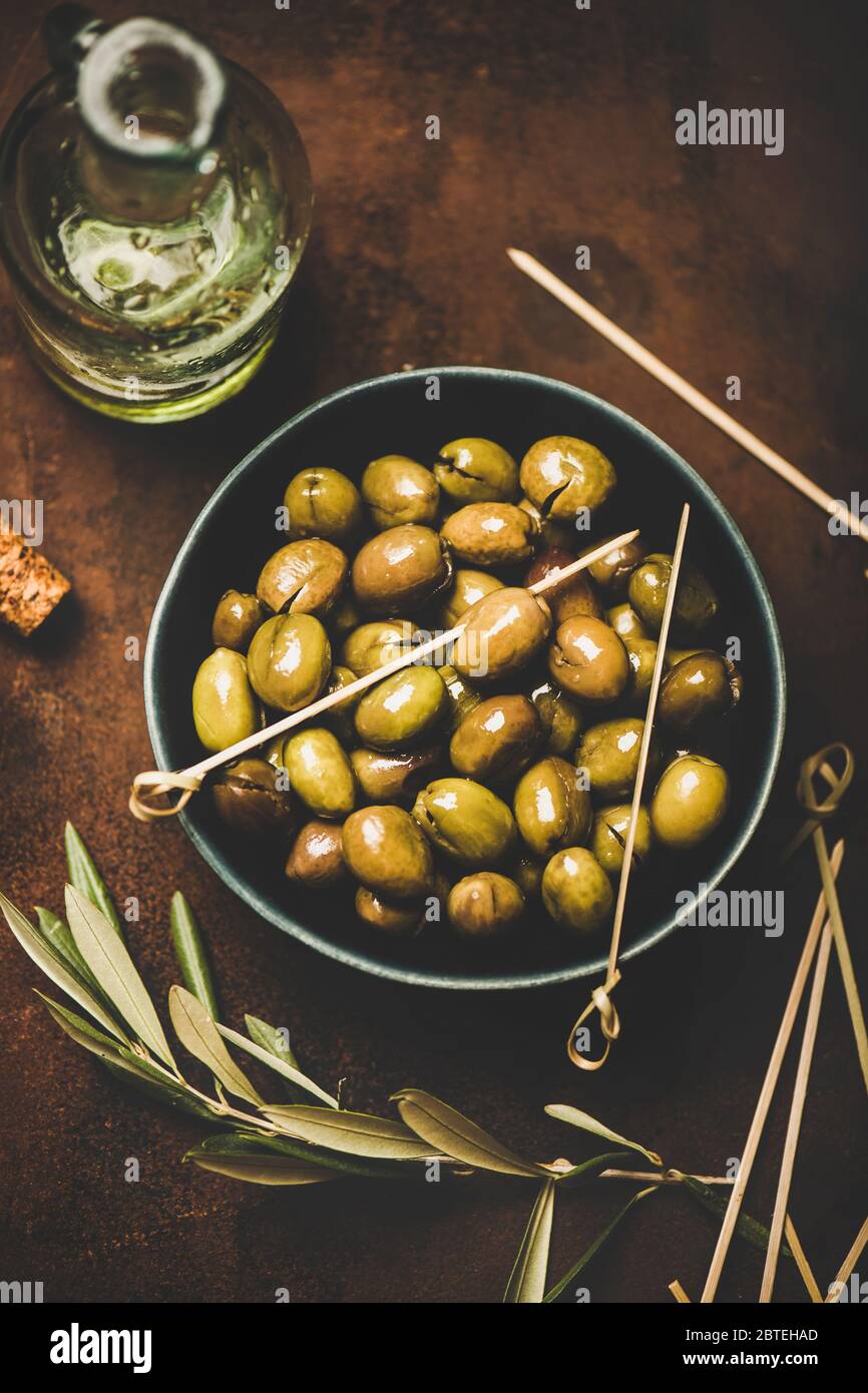 Flat-lay of fresh harvested seasonal pickled green Mediterranean olives ...