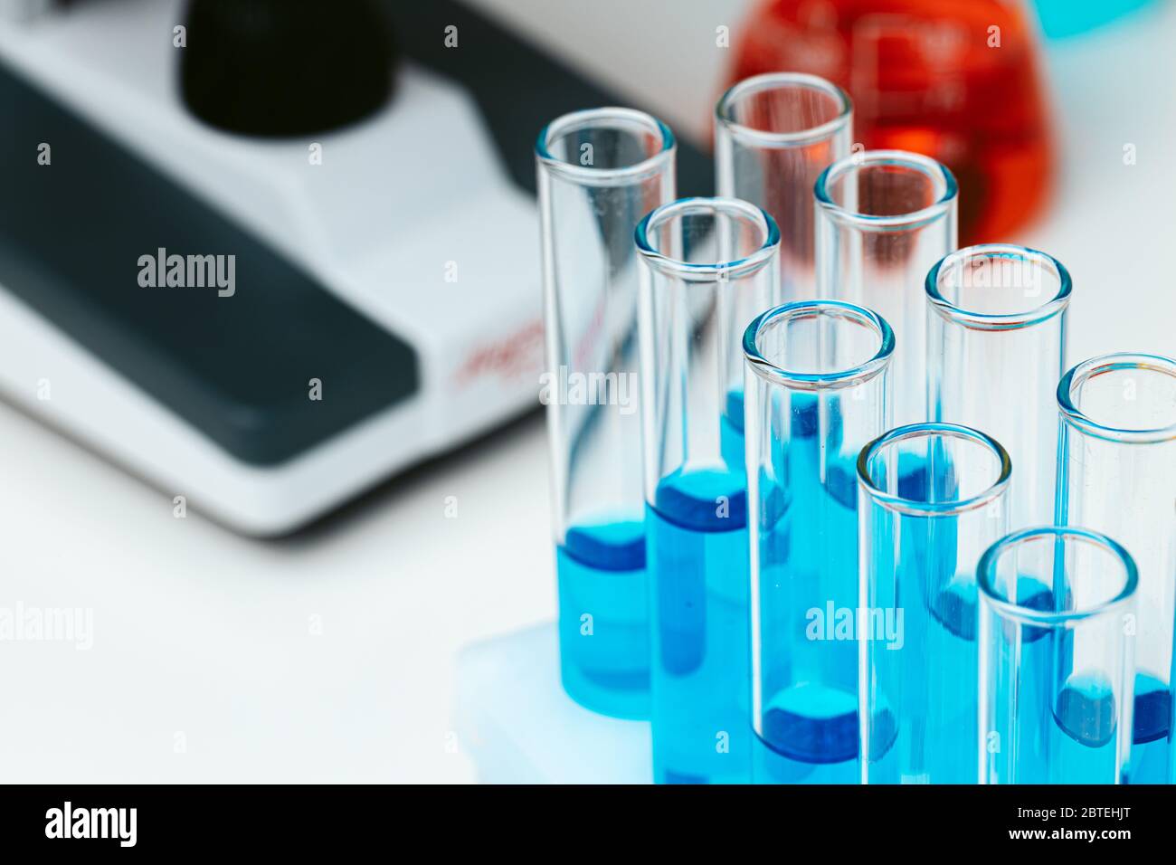 Scientific laboratory with microscope and test tubes with samples ...
