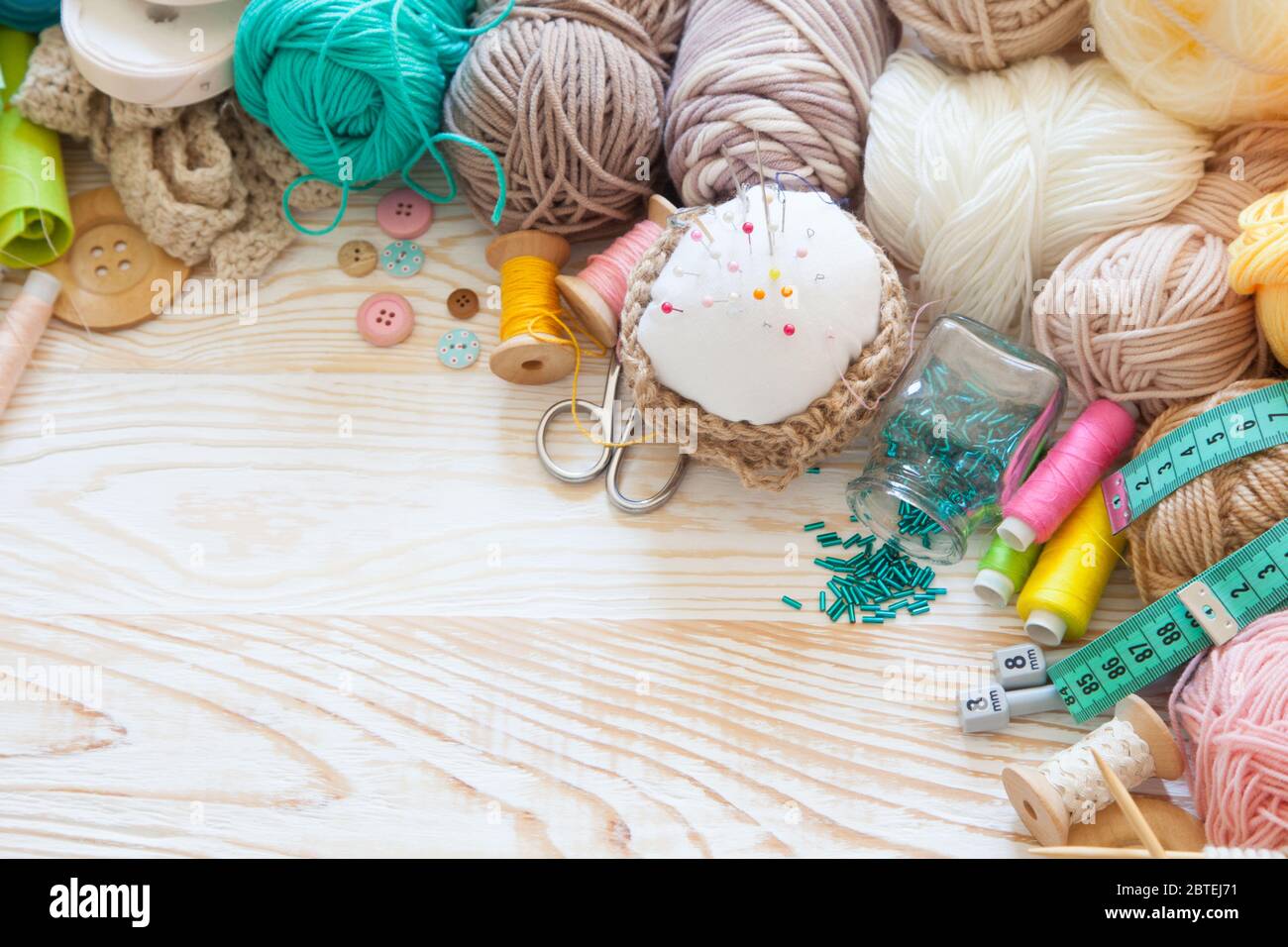 Many different rainbow materials for needlework and sewing. A girl ...