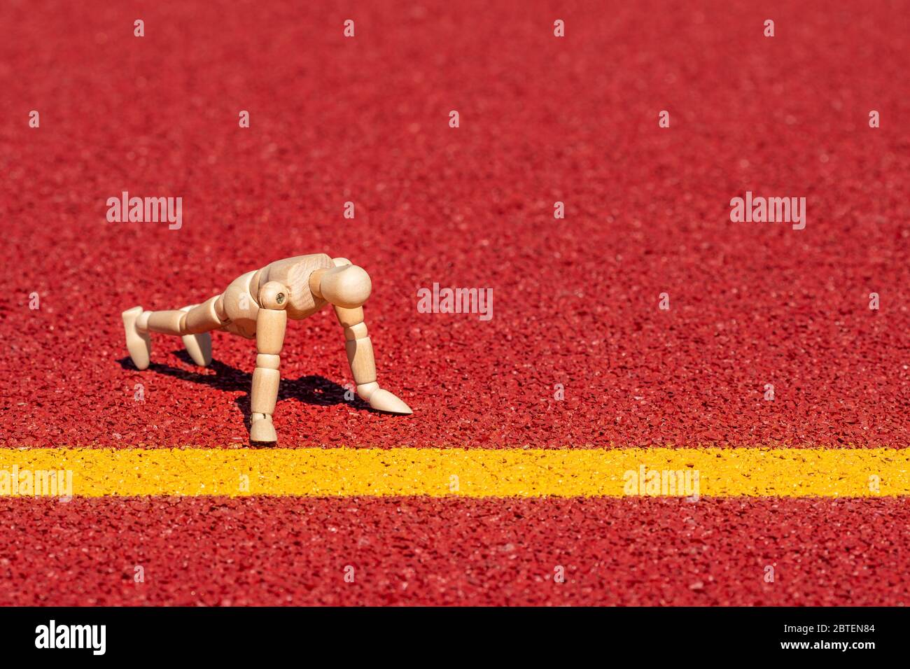Wooden man doing push ups on running track. Healthy life concept Stock ...
