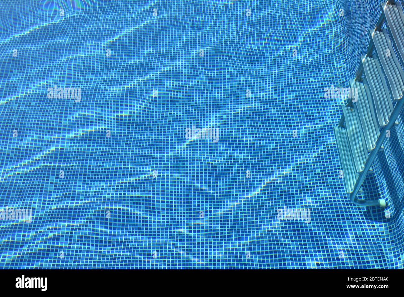 Clear water in swimming pool with blue bottom Stock Photo - Alamy