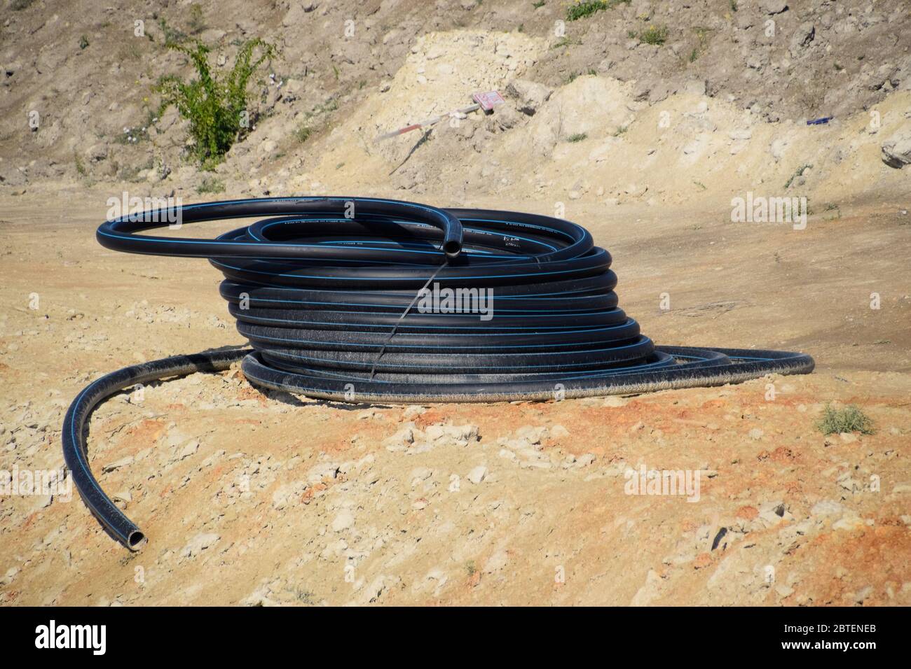 A plastic pipe rolled into the bay. Laying a plumbing pipe Stock Photo ...