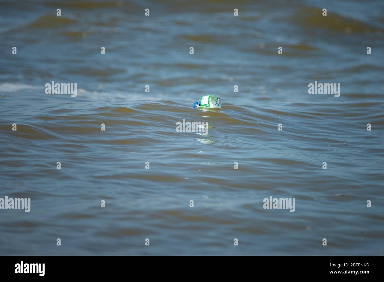 Plastic water bottle floating on the ocean Stock Photo - Alamy