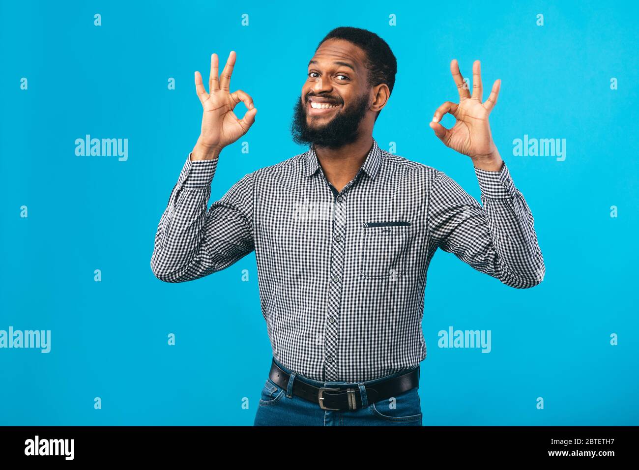 Happy african guy gesturing ok sign and smiling Stock Photo - Alamy