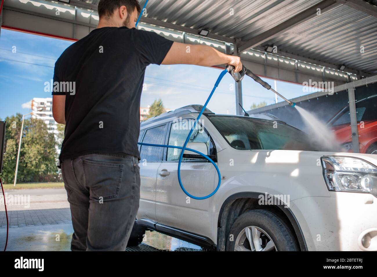 strong man washing car at self carwash outdoors Stock Photo - Alamy