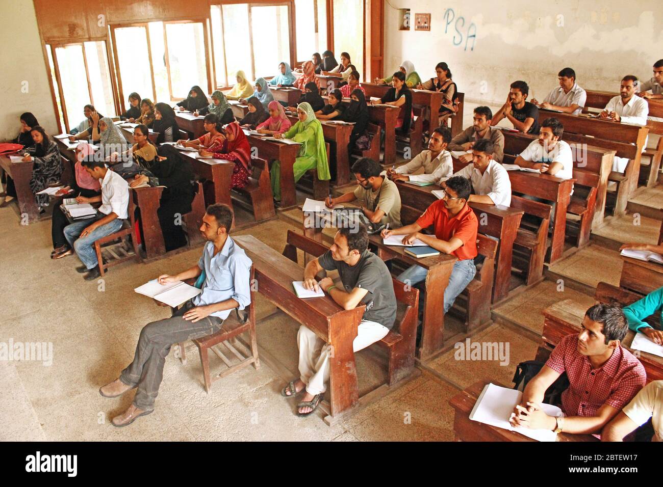 Students are sitting during lecture in class room while listening to ...