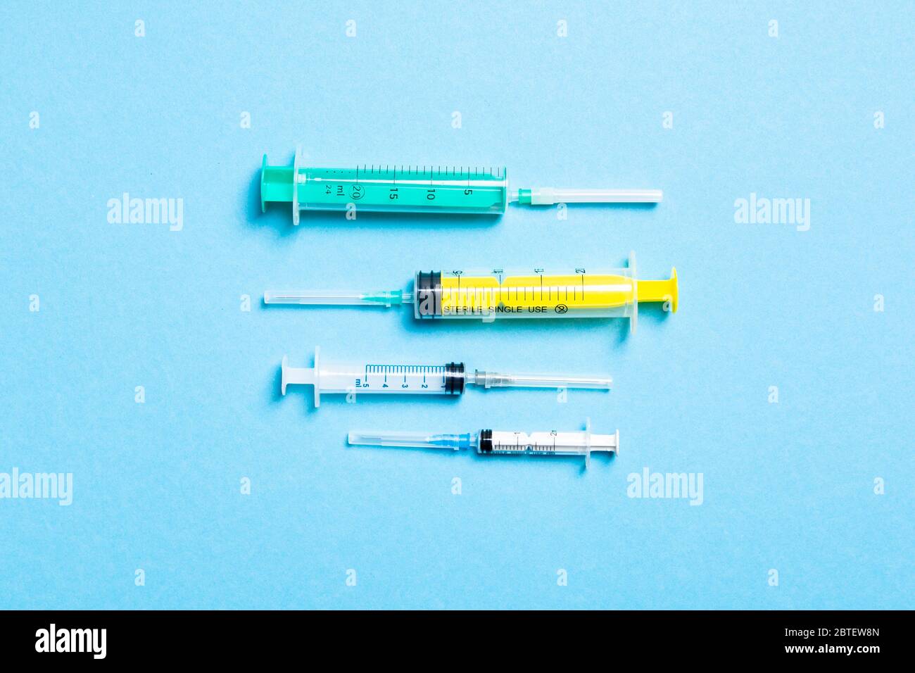 Top view of different syringes at blue background. Medical injection ...