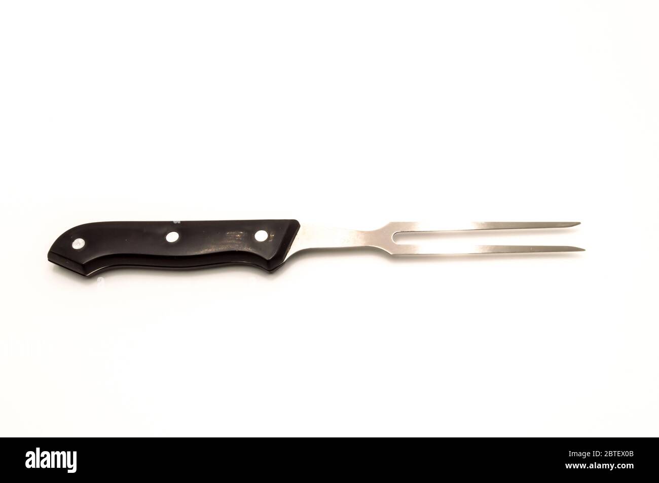 Meat fork with a black wooden handle, isolated on a white background ...