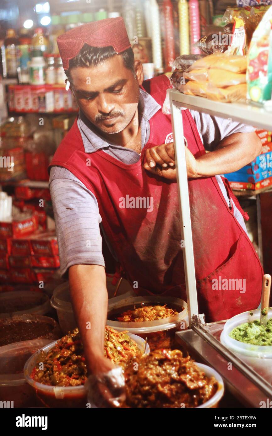 Sales man wearing sindhi hat selling achaar at sadar bazar karachi ...