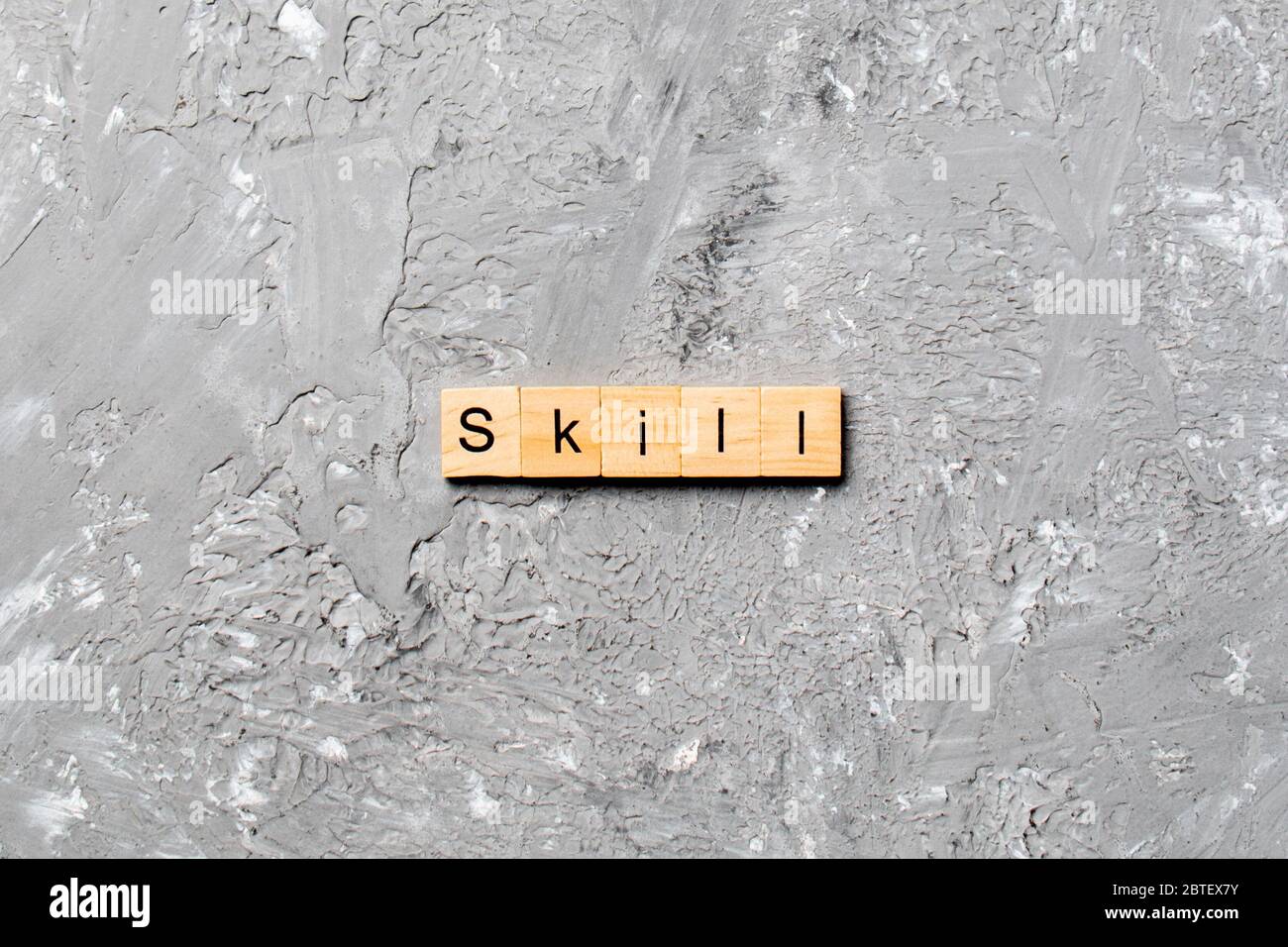 Skill word written on wood block. Skill text on cement table for your ...