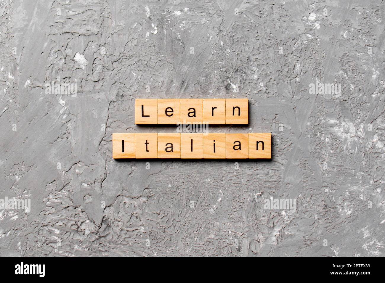 learn italian word written on wood block. learn italian text on table ...
