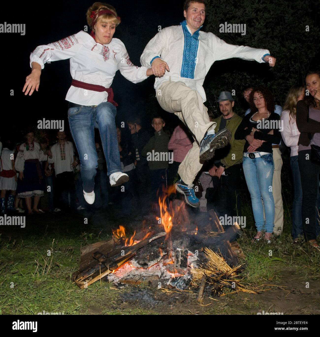 Kiev, Kievskaya Oblast/Ukraine - 07.06.2011. Young couple jumping over ...