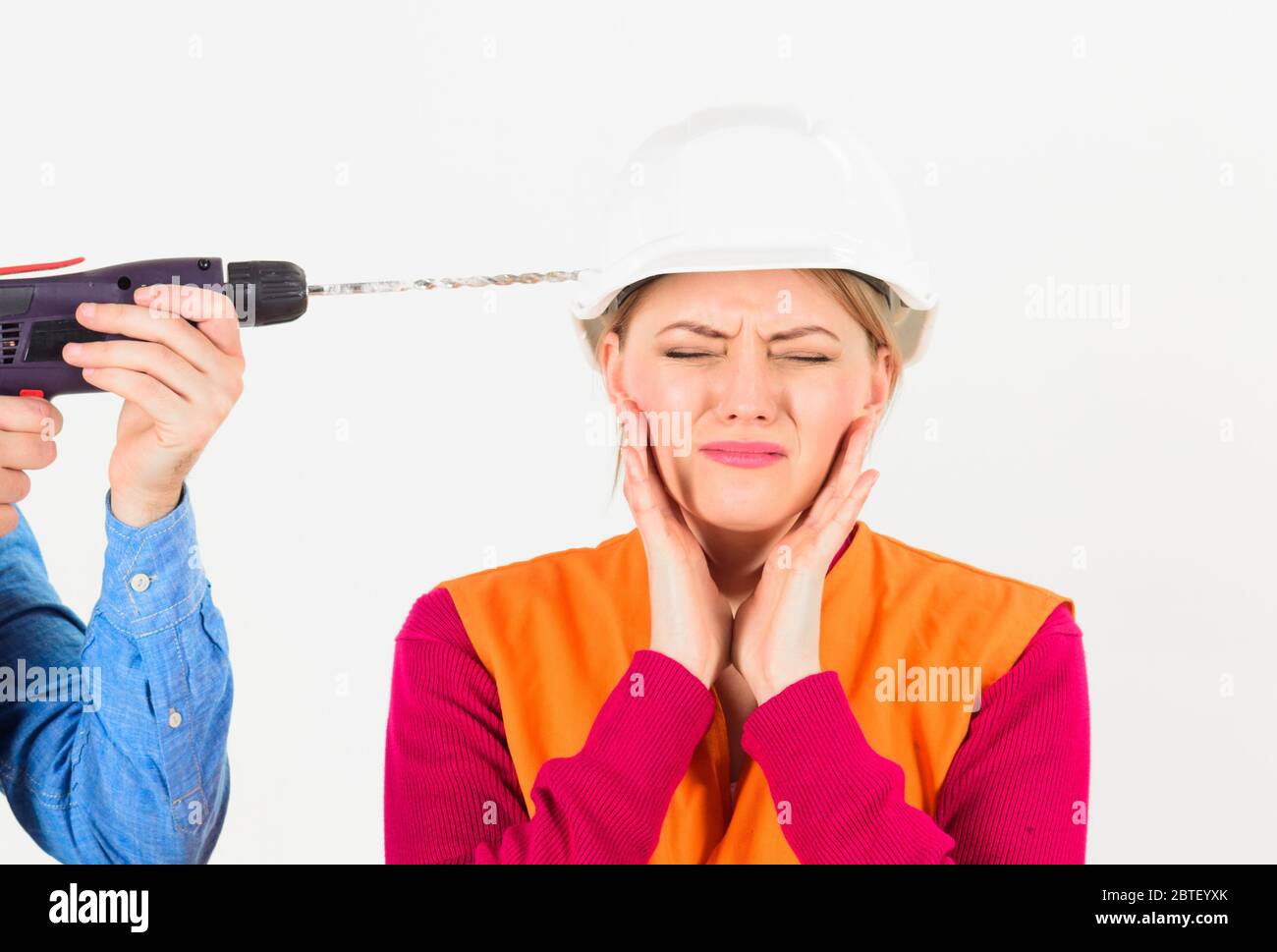 Incompetent female worker with drill on white background. Woman with ...