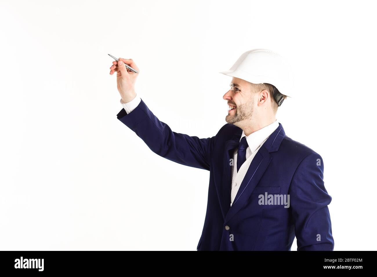 Businessman or engineer holds pen on white background. Engineering and ...