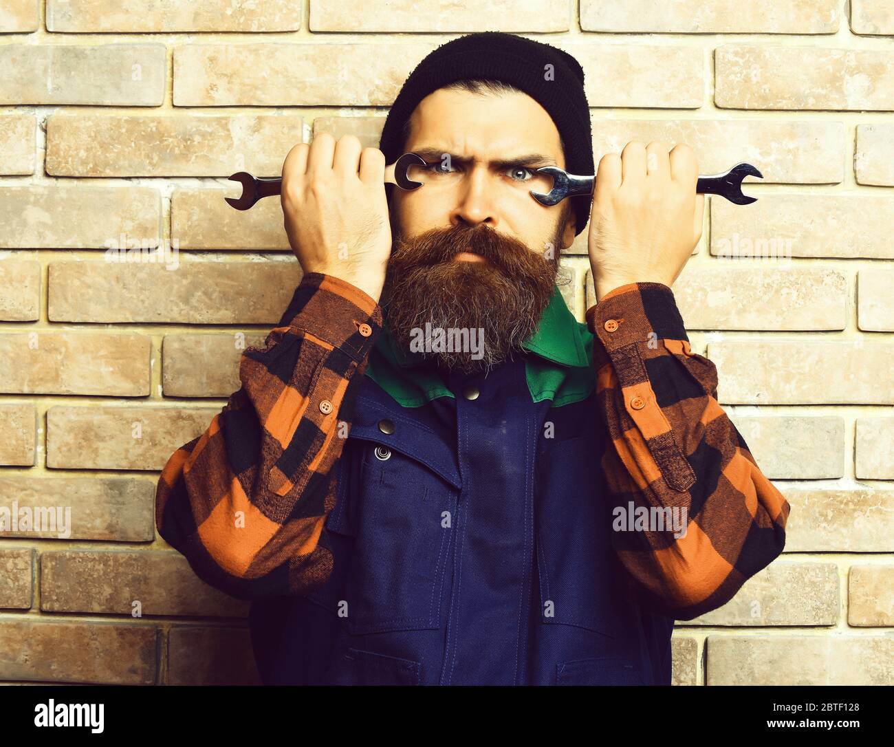 Bearded man, long beard. Brutal caucasian mechanic, unshaven hipster in ...