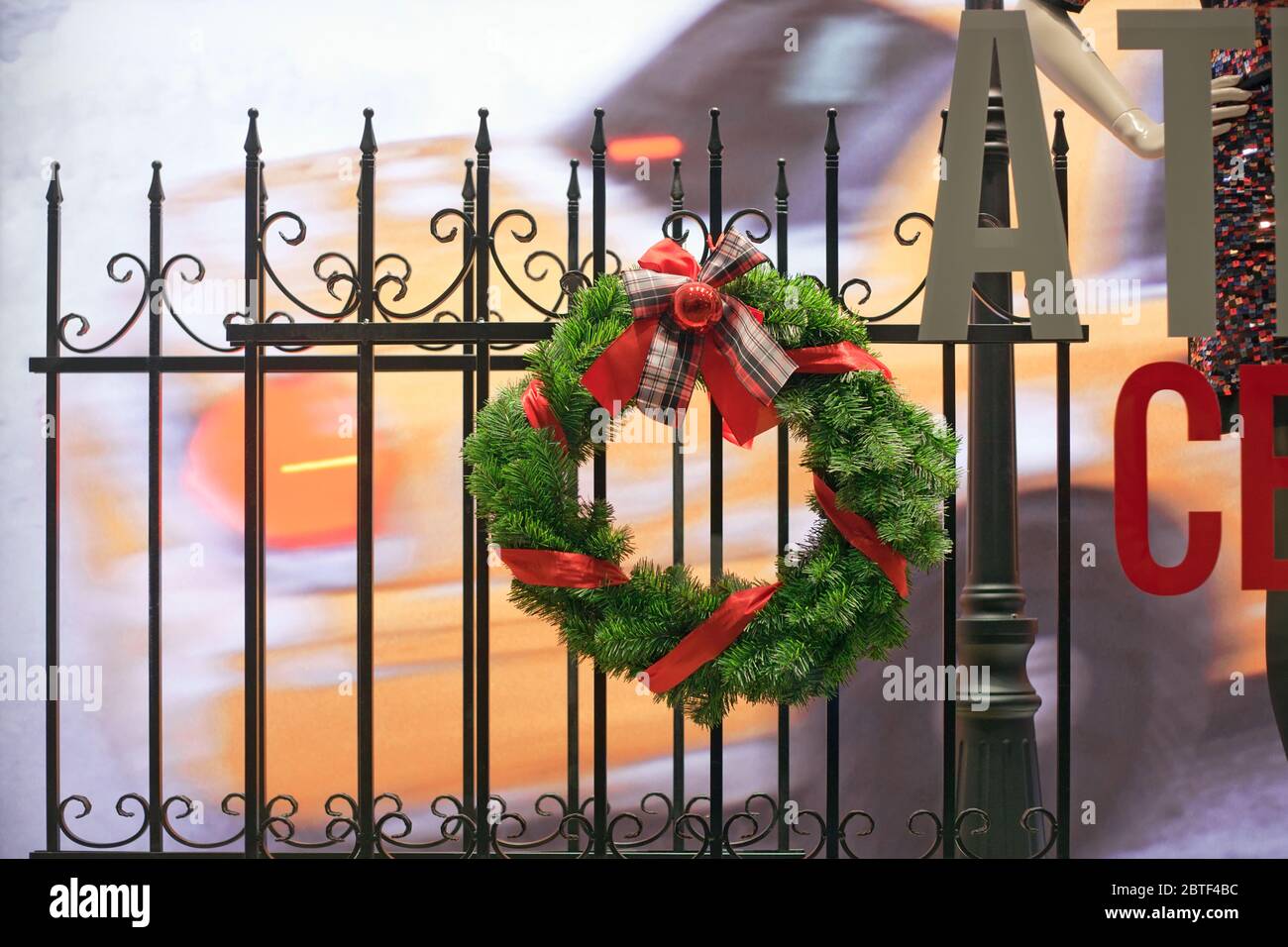 Green Christmas wreath with decorations on store window display Stock ...