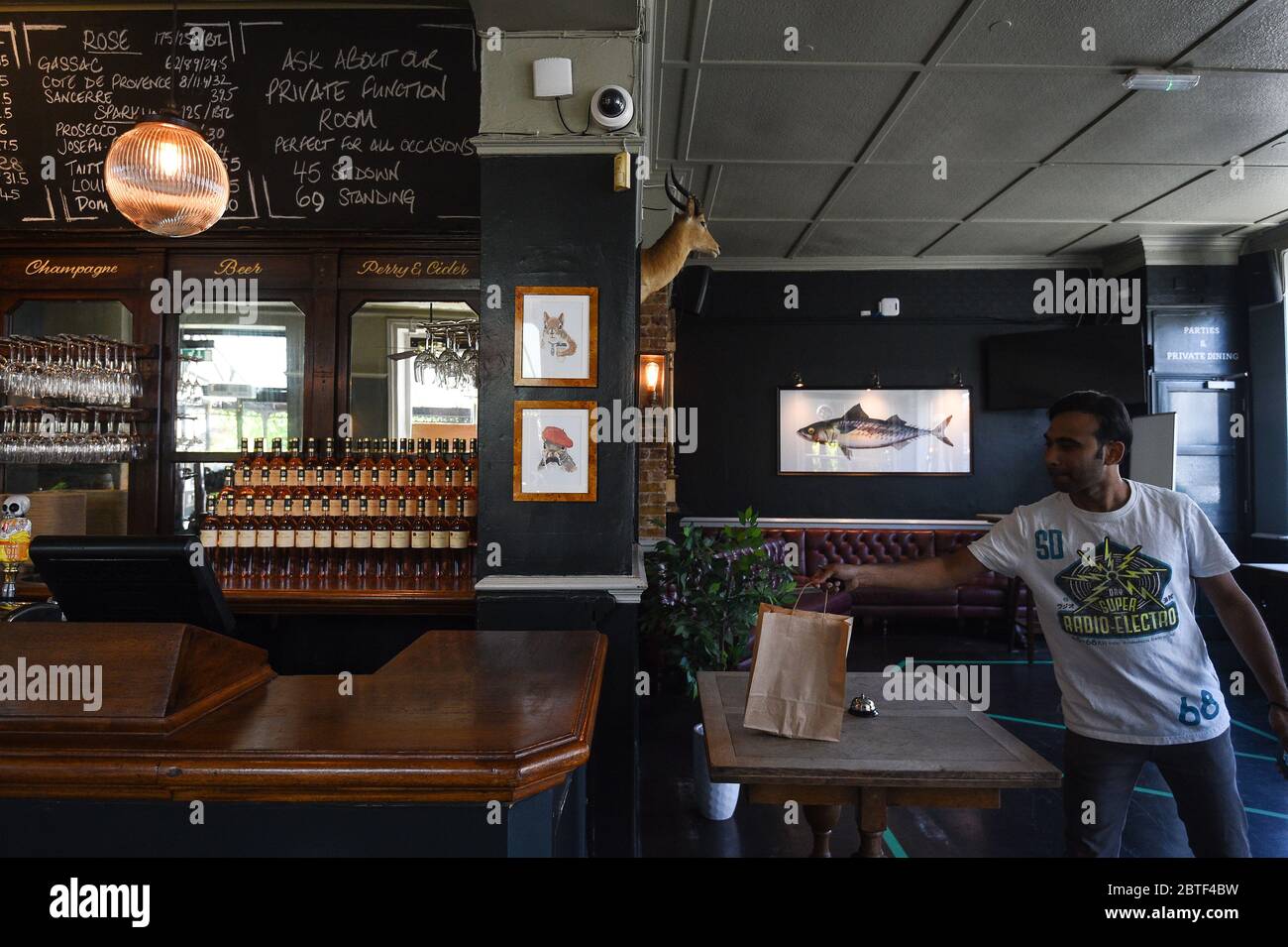 A deliveroo deliver collets a take away order from The Crabtree pub in ...
