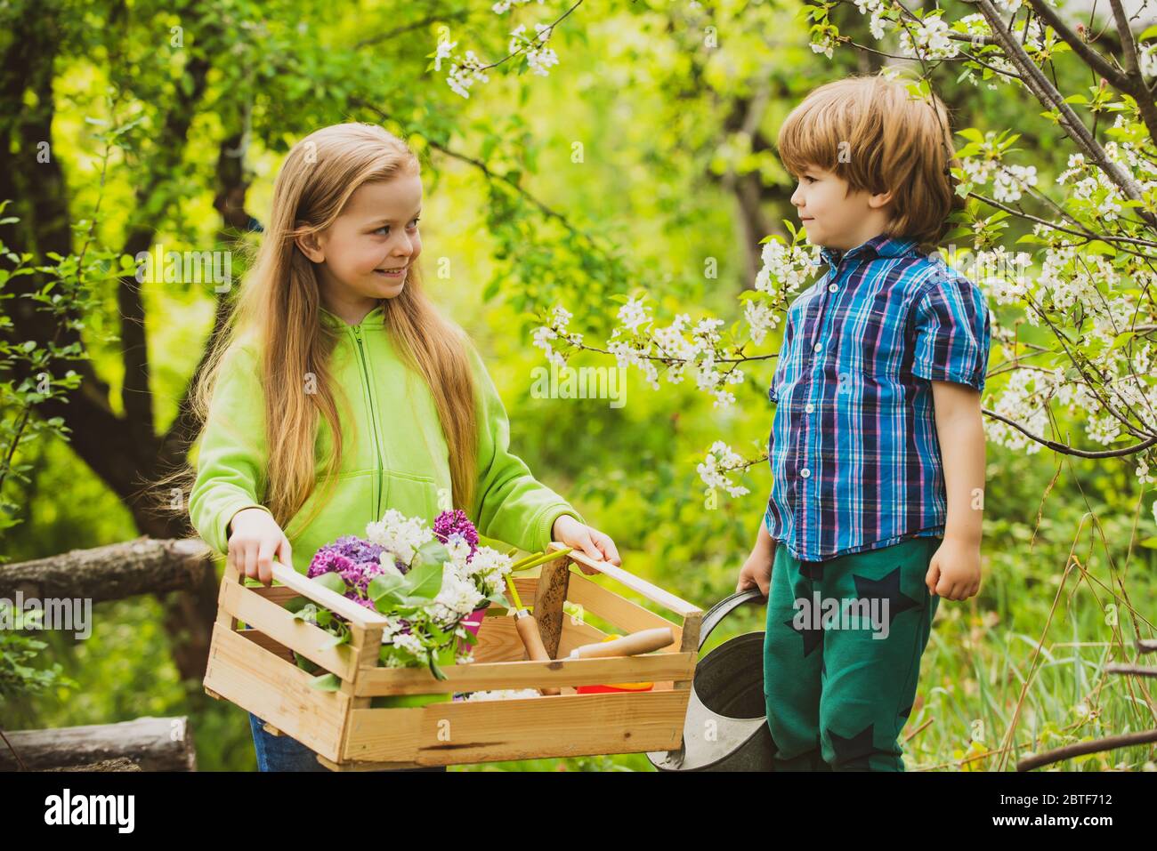 Eco living. Happy children farmers having fun on spring field. Children ...