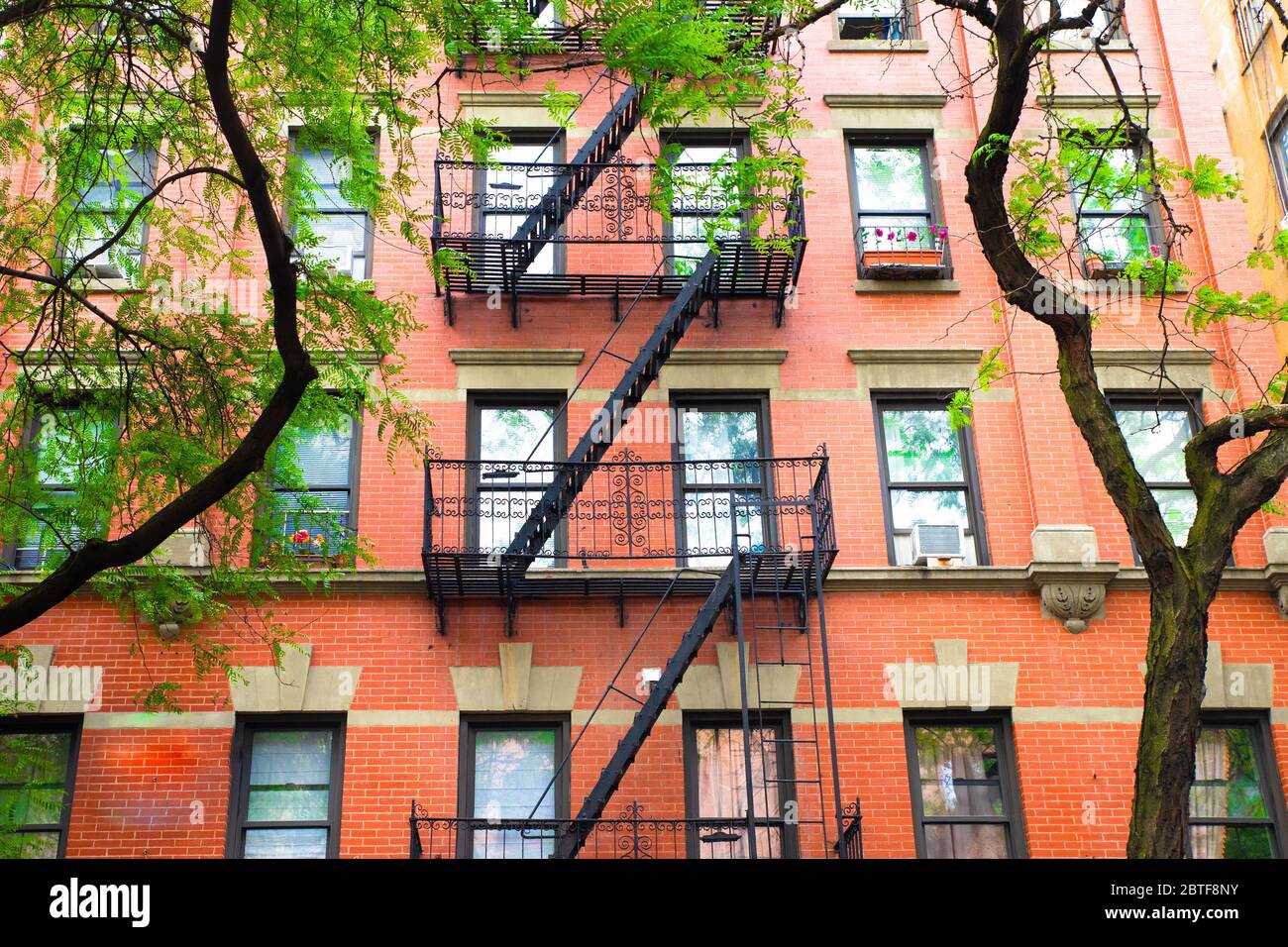 Typical New York City Brick Apartment Building In Spring Surrounded By