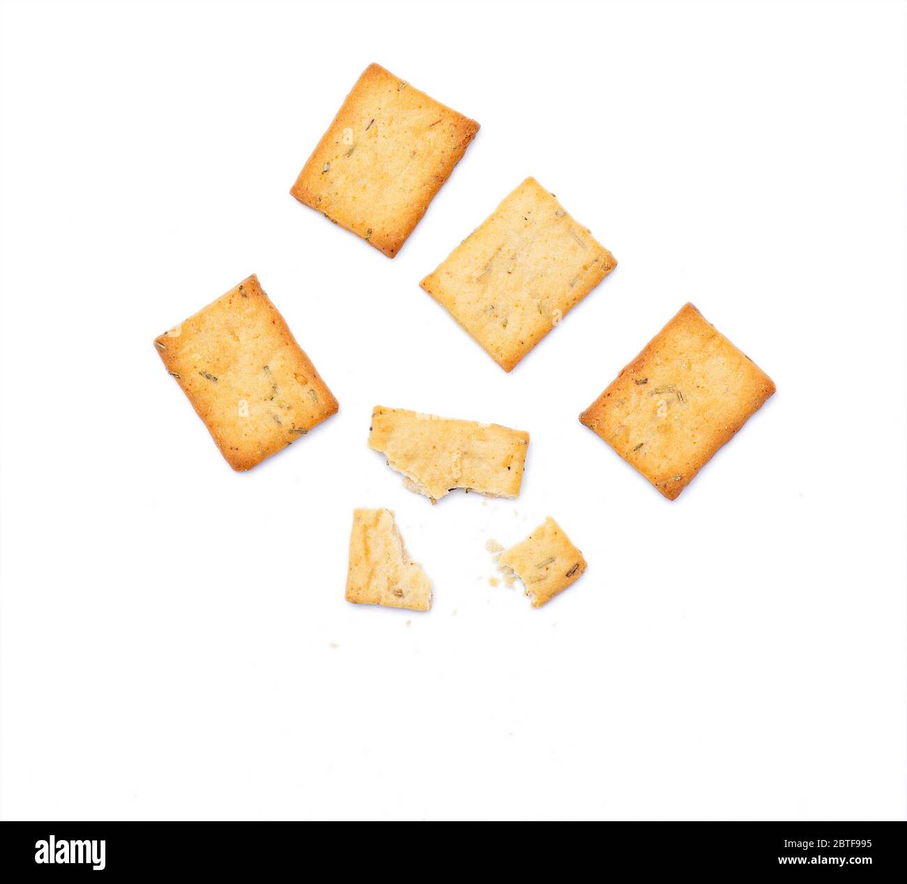 Some pieces of square multi grain baked crackers isolated on white ...