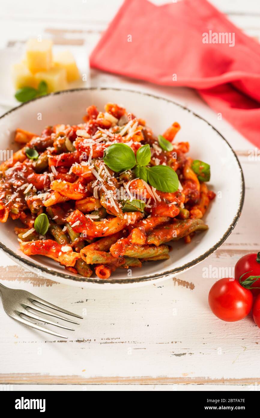 Vertical crop shot of italian pasta penne plate with tomato sauce and ...
