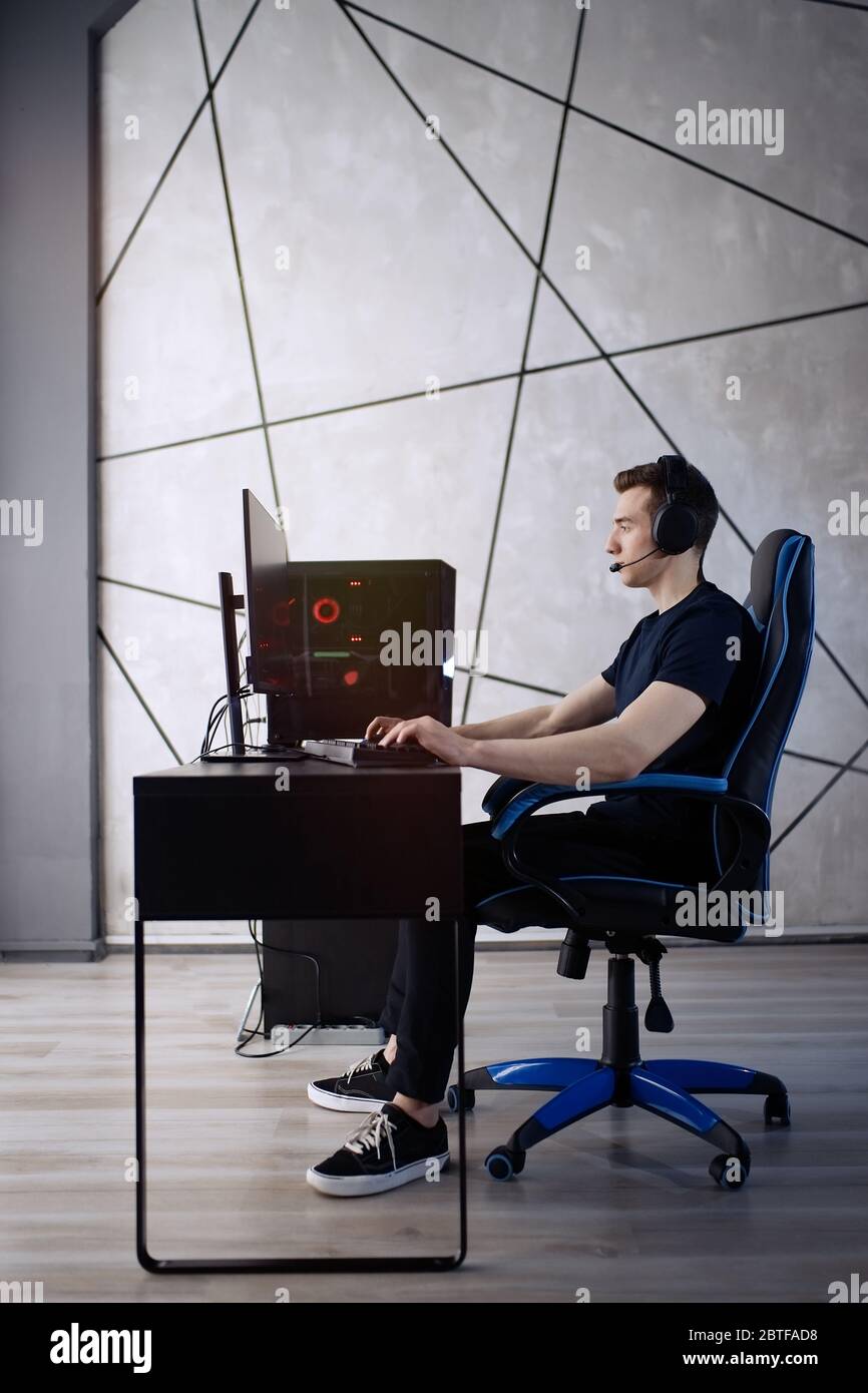 Professional gamer playing online video game at night time Stock Photo ...