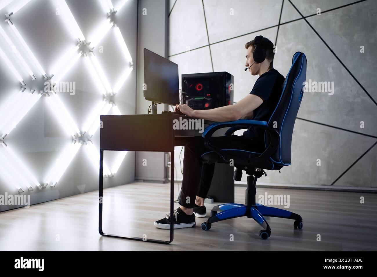 Professional gamer playing online video game at night time Stock Photo ...