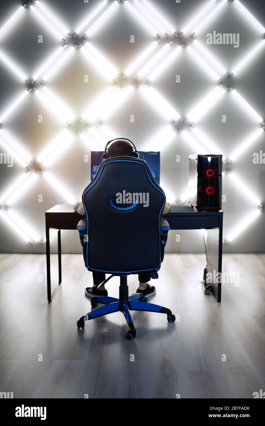 Professional gamer playing online video game at night time Stock Photo ...