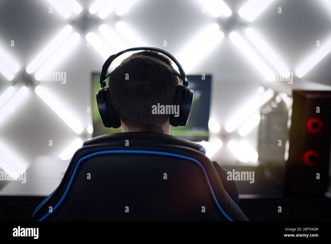 Professional gamer in his expensive studio having live stream playing ...