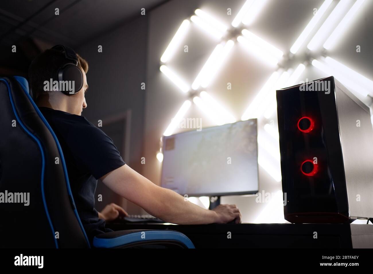 Professional gamer in his expensive studio having live stream playing ...