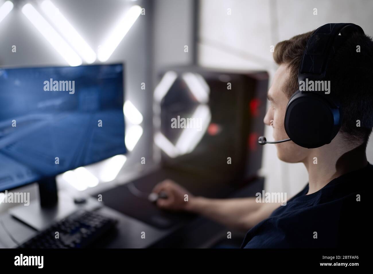 Professional gamer in his expensive studio having live stream playing ...
