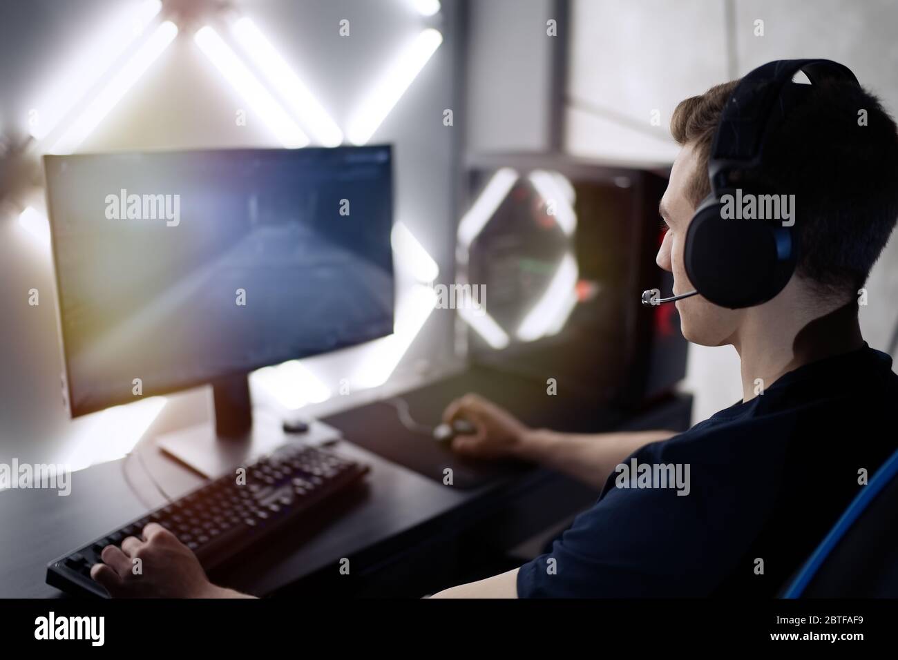 Professional gamer in his expensive studio having live stream playing ...